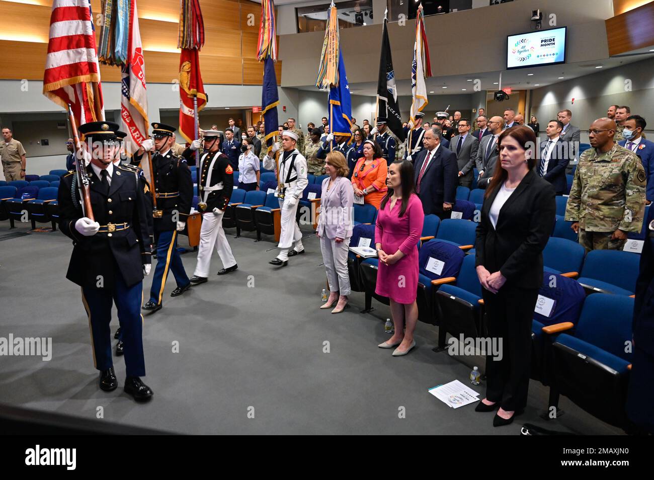 An honor guard parades flags during a Department of Defense Pride ...