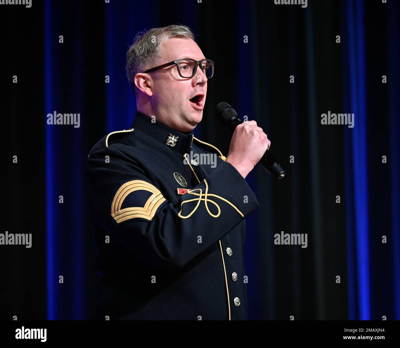 Army Master Sgt. Matthew Heil sings the national anthem during a ...