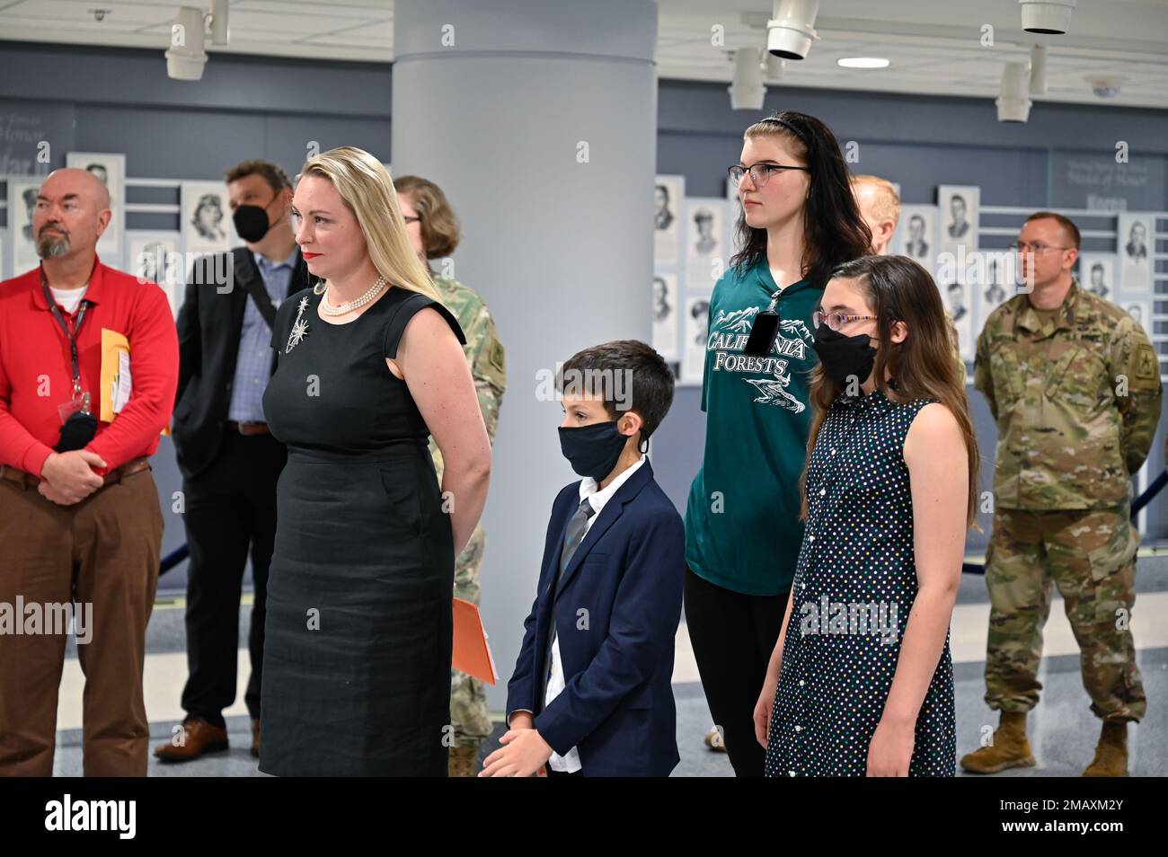 The family of Col. Louis Melancon listens during his transfer ceremony ...