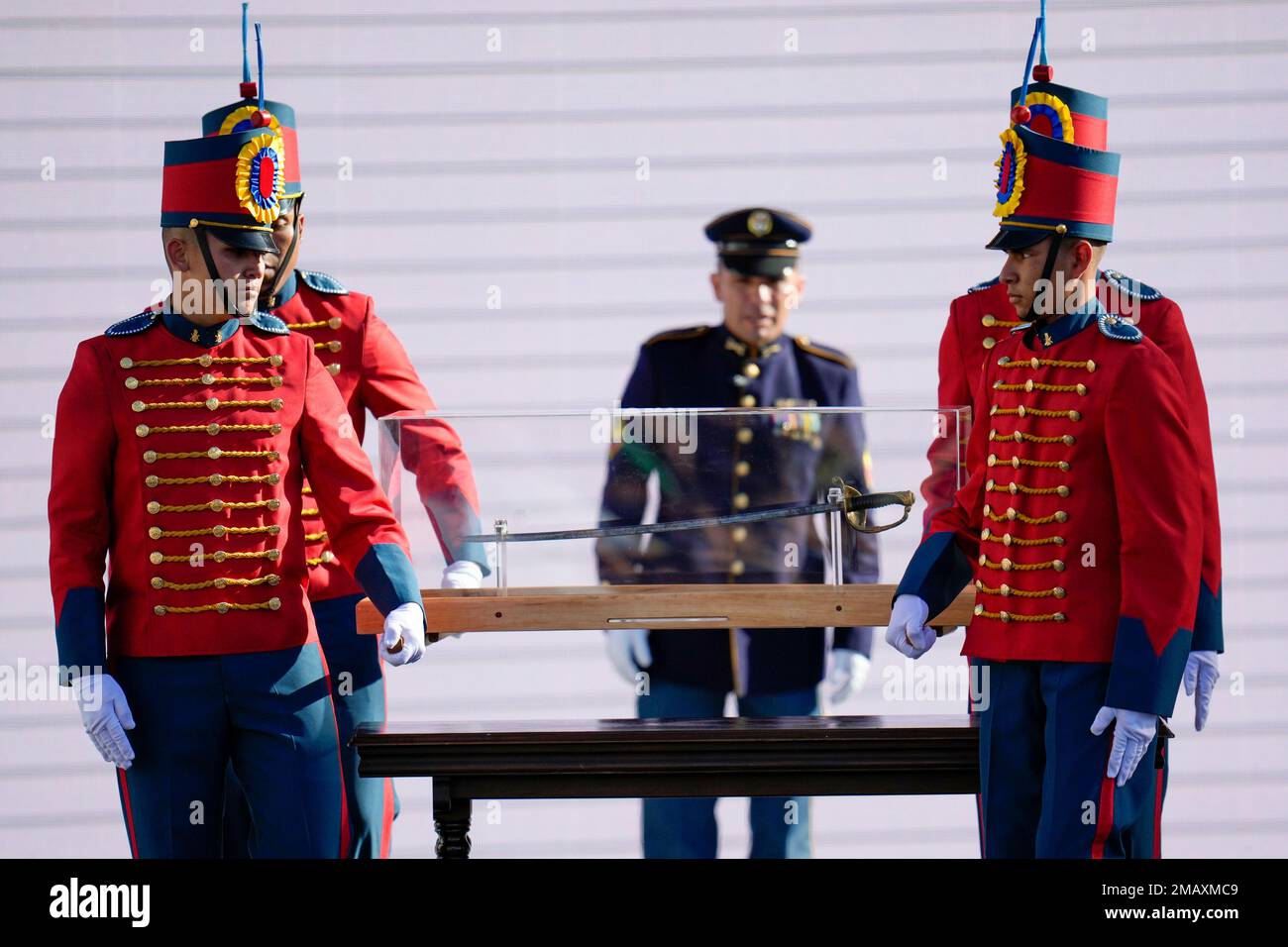Members of the Presidential Guard carry the sword of independence hero ...