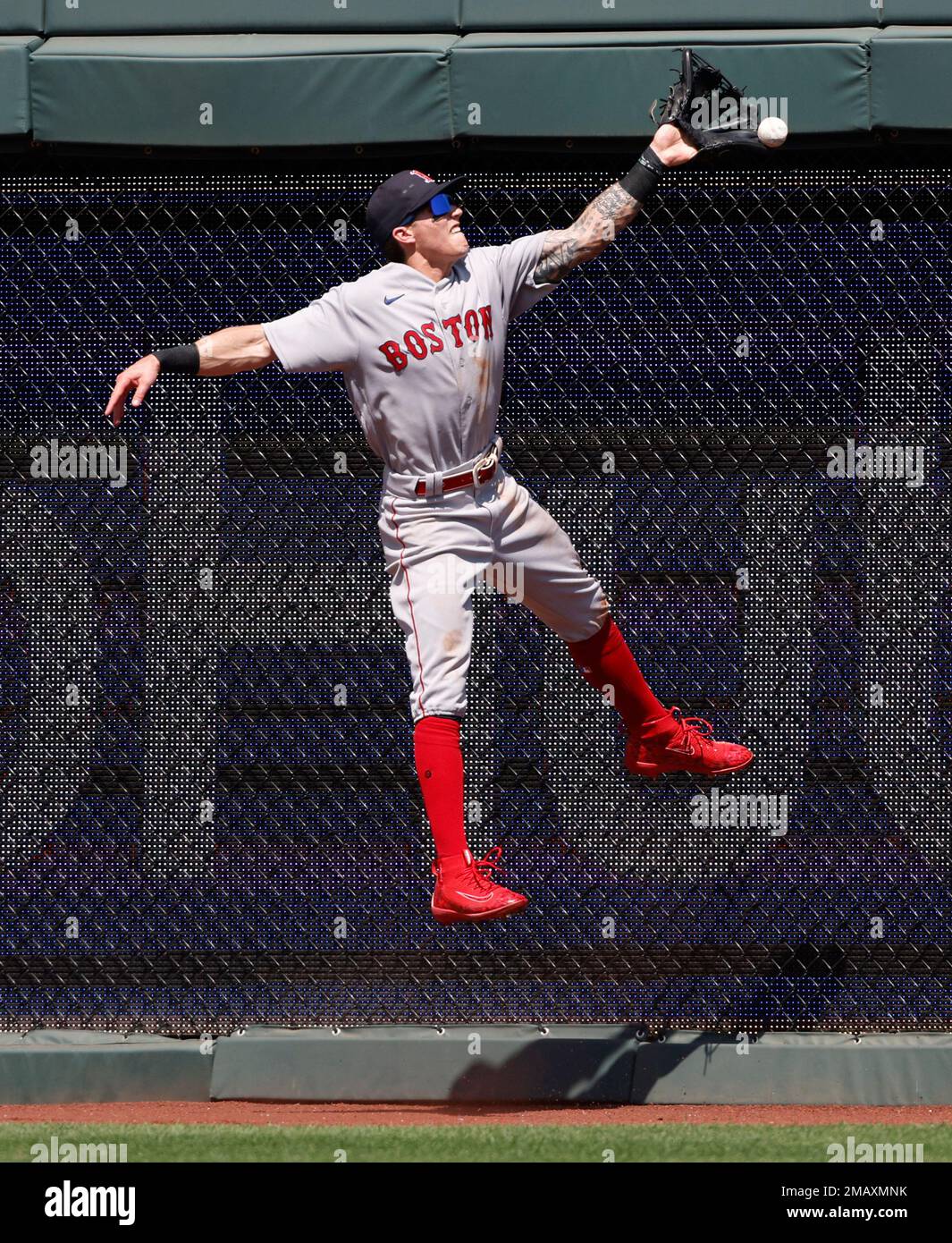 Boston Red Sox center fielder Jarren Duran is unable to catch a fly ball hit by Kansas City ...