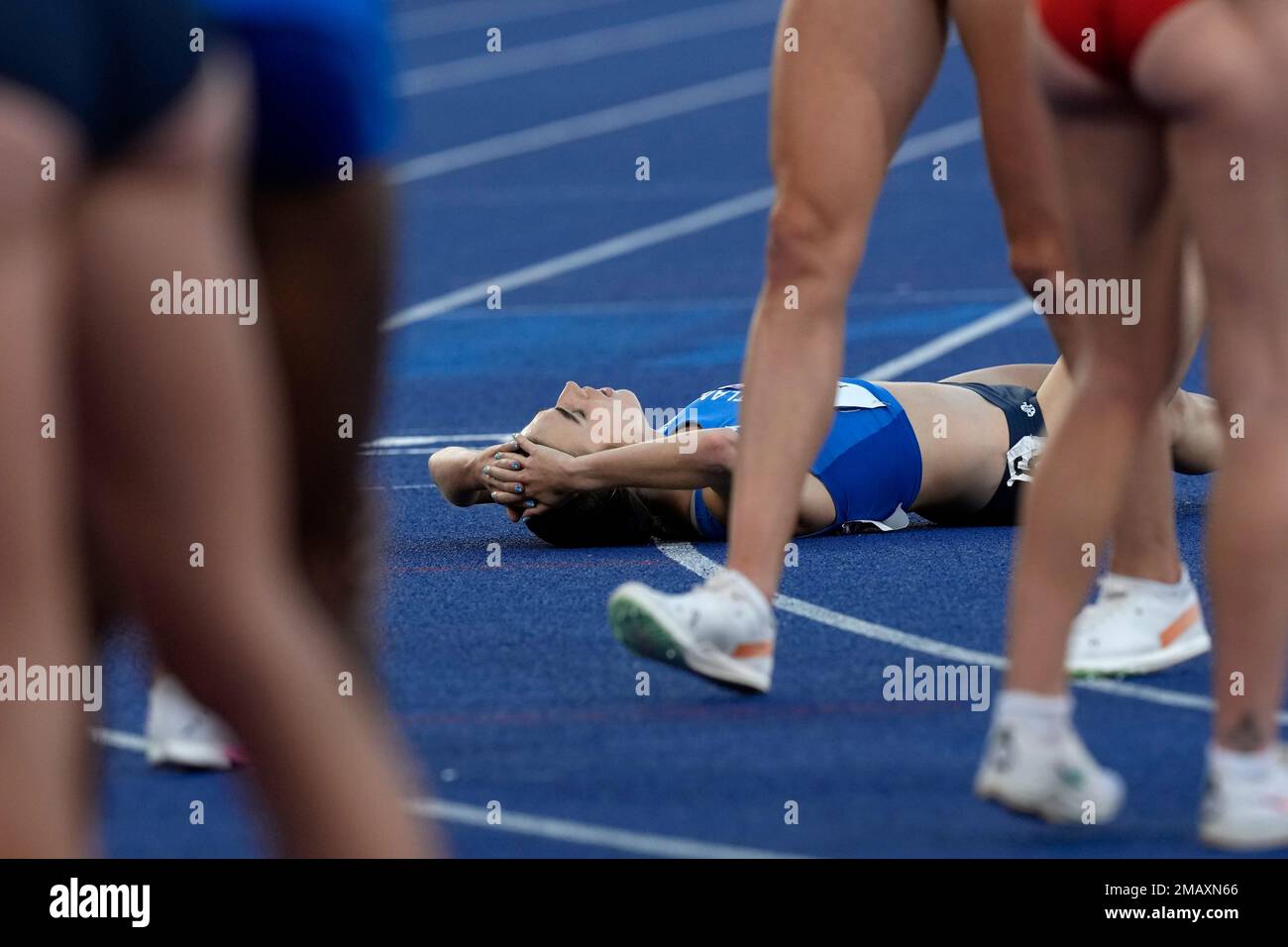 Eloise Walker of Scotland collapses on the track after crossing the ...