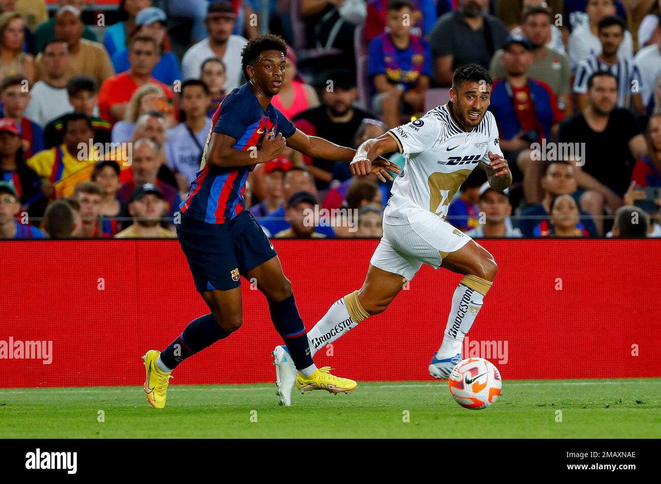 Mexico's Pumas Eduardo Salvio, right, runs for the ball with Barcelona ...