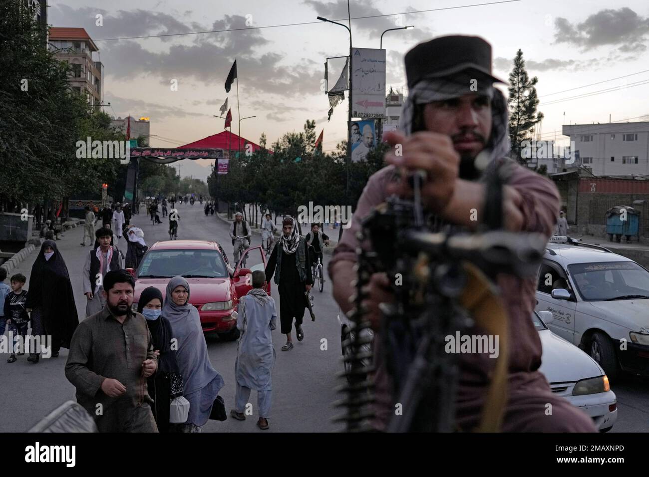 Taliban fighters stand guard in the Shiite neighborhood of Dasht-e ...