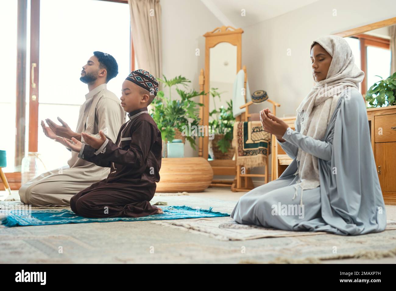 Our prayers do make a difference. a young muslim couple and their son ...