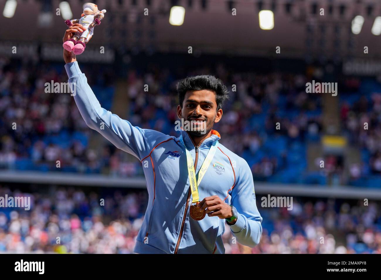 Men's triple jump gold medalist Eldhose Paul, of India gestures on the podium during the ...