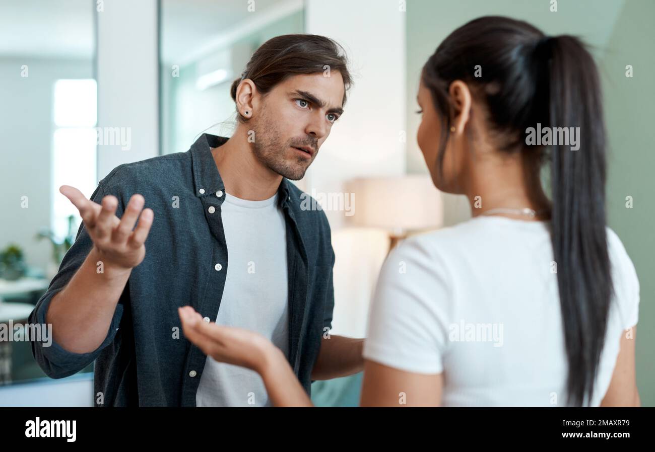 What are you saying. a young couple having an argument at home Stock ...