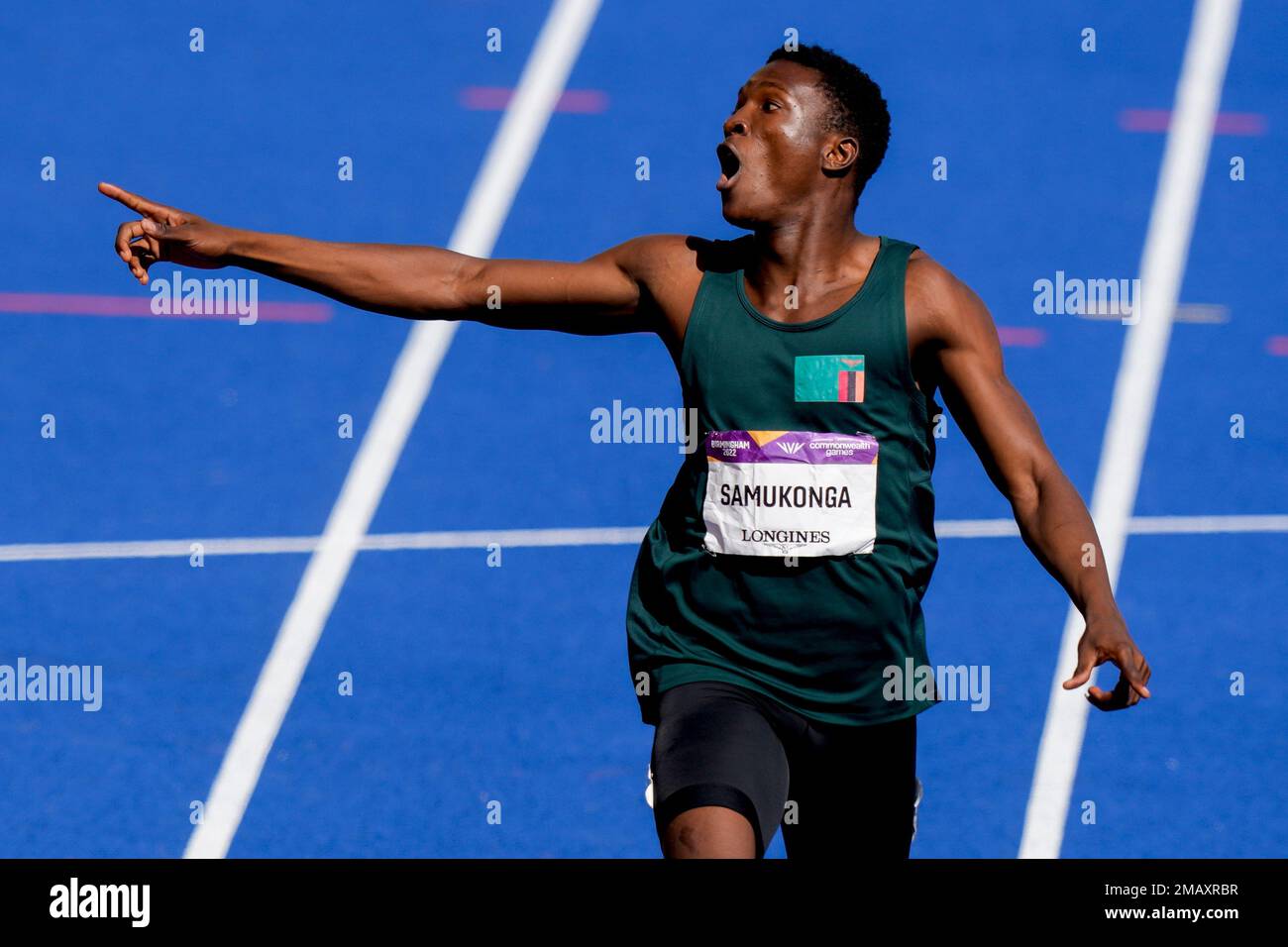 Muzala Samukonga, of Zambia reacts as he crosses the finish line to win ...