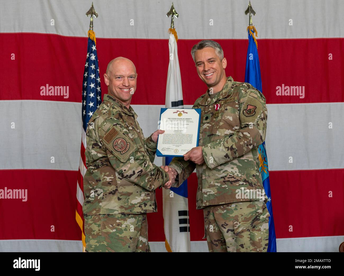 Col. Mathew Gaetke, 51st Operations Group commander, left, presents Lt. Col. William Yoakley ...