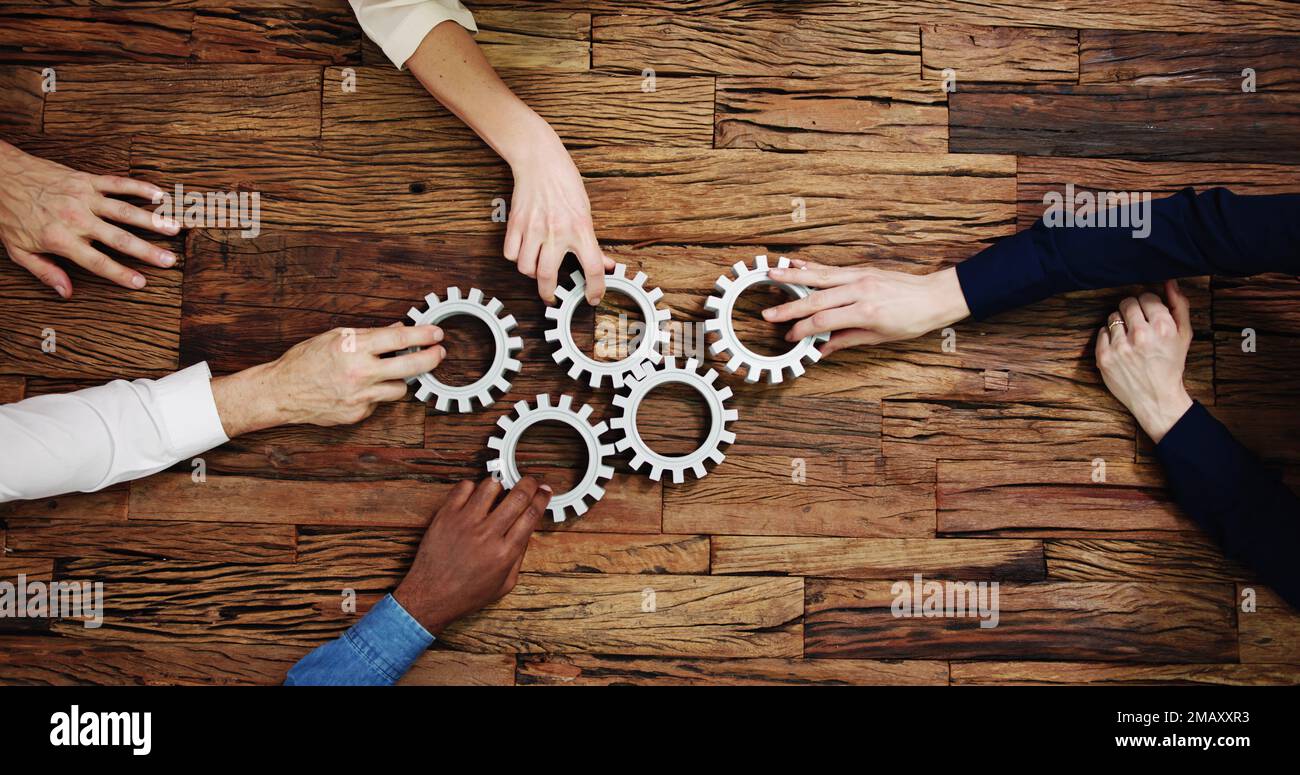 Hands Holding Interlocked Gear Wheels. Business Partnership Stock Photo ...