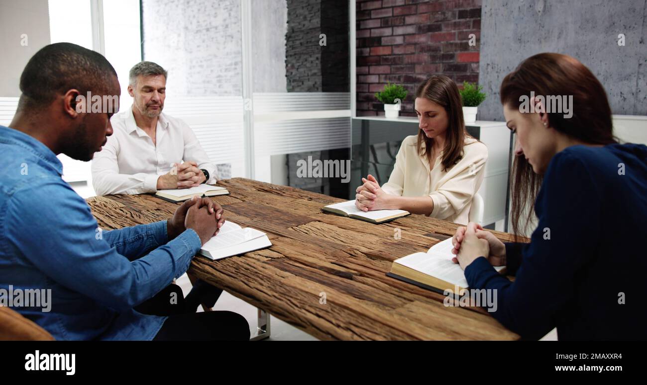 Group Of People Reading Bible On Wooden Desk Stock Photo - Alamy