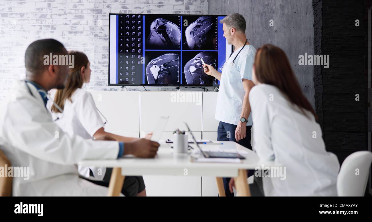 Physician Doctors Looking At Shoulder MRT Scan Stock Photo - Alamy