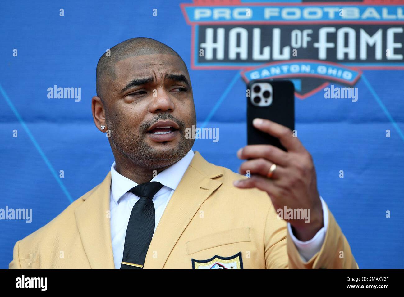 Former NFL player Richard Seymour takes photos of the scene during an ...