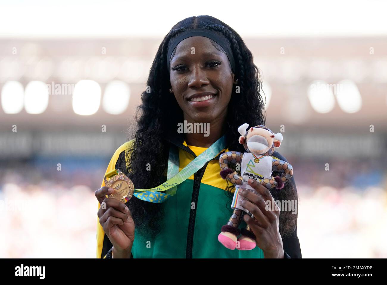 Lamara Distin of Jamaica poses on the podium after winning the gold ...