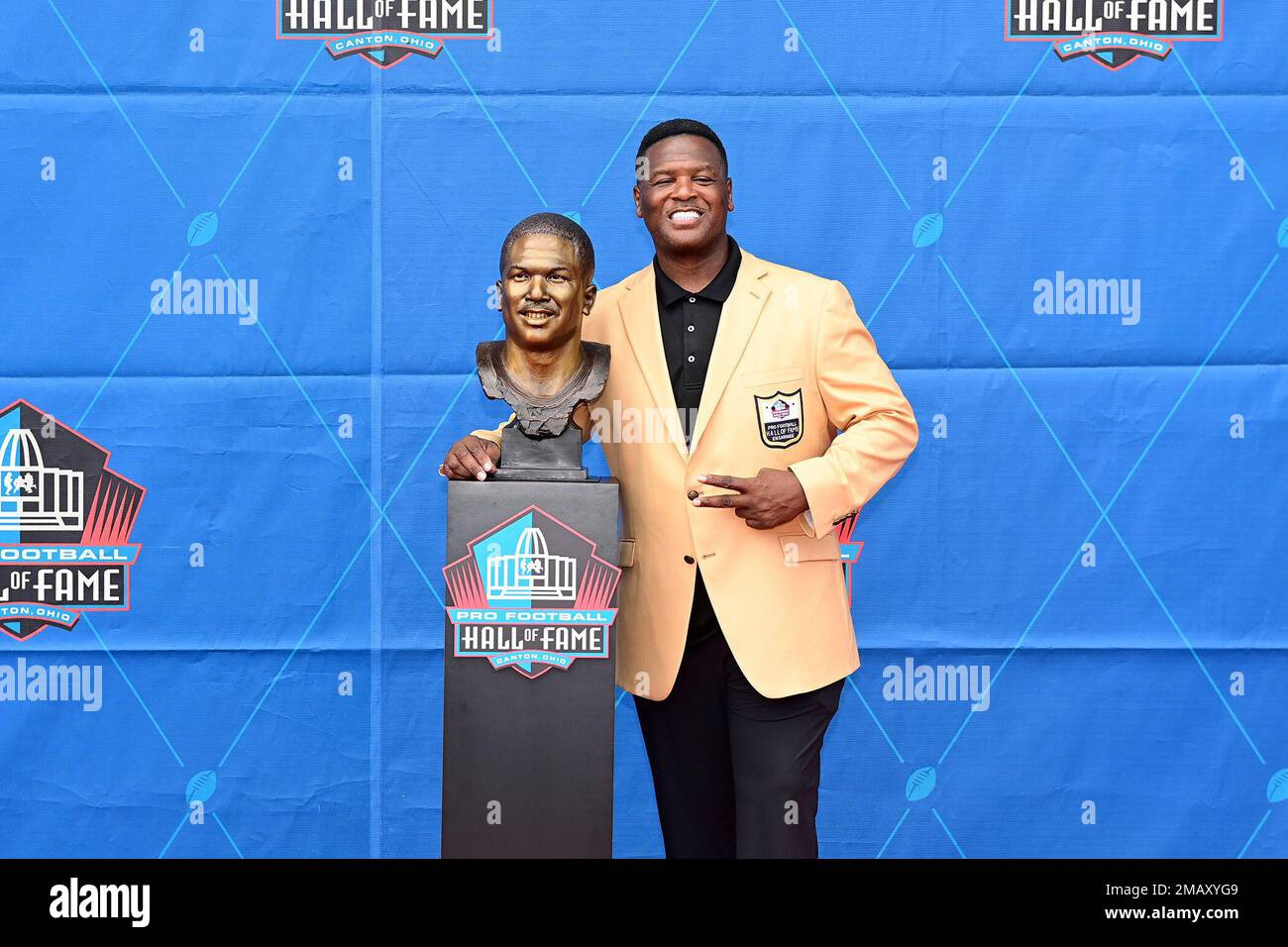Former NFL player Leroy Butler poses with his bust during an induction ...