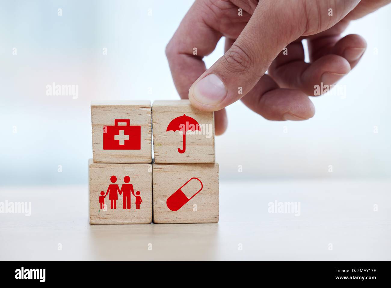 Family, healthcare and hand with blocks for insurance, medical future ...