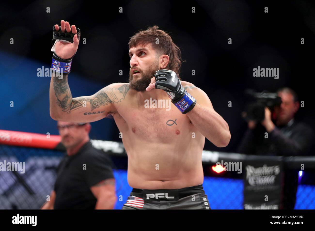 Josh Silveira lands a kick to the body of Omari Akhmedov during their ...