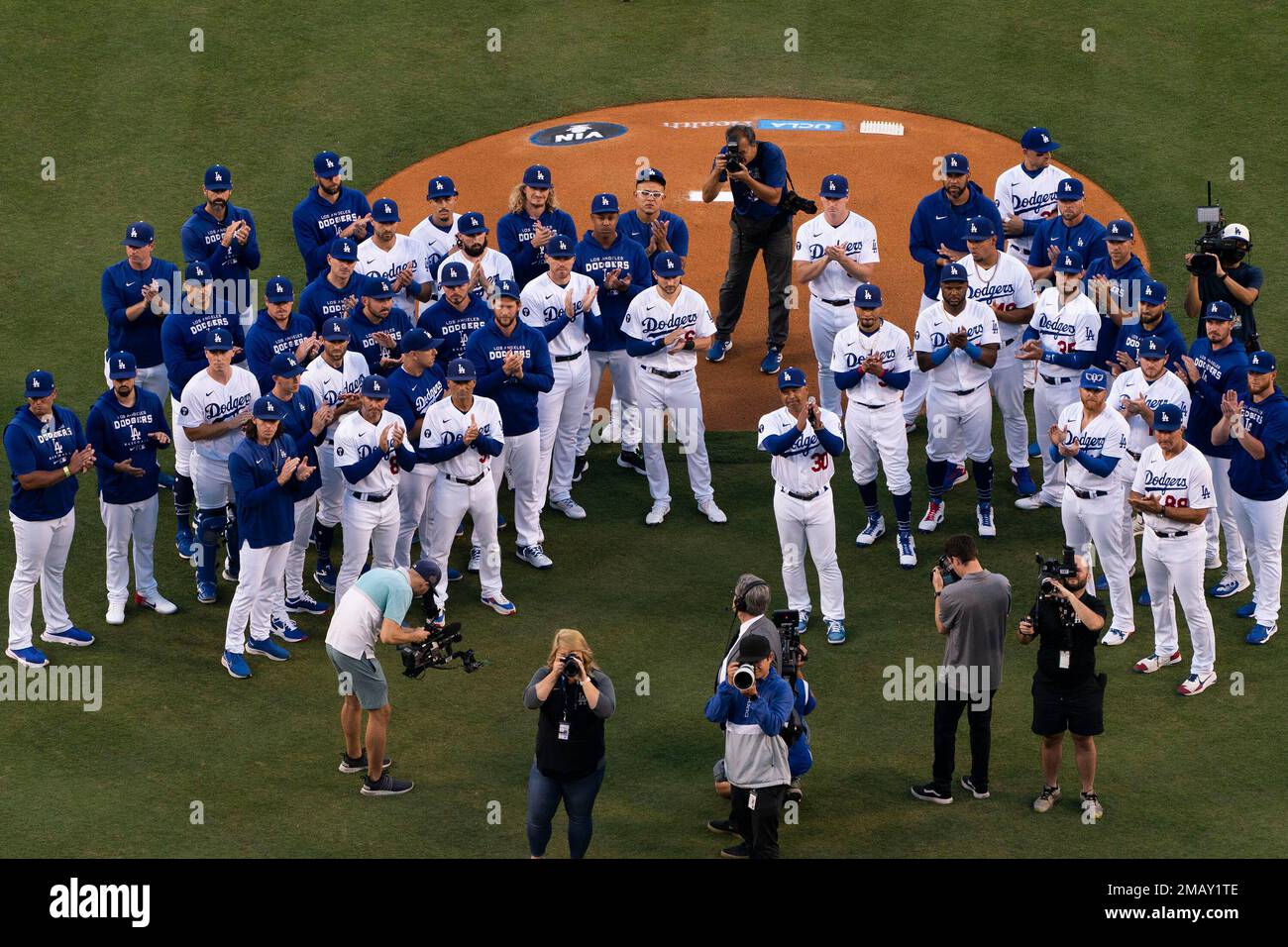 Los Angeles Dodgers players and coaches gather around the mound during ...