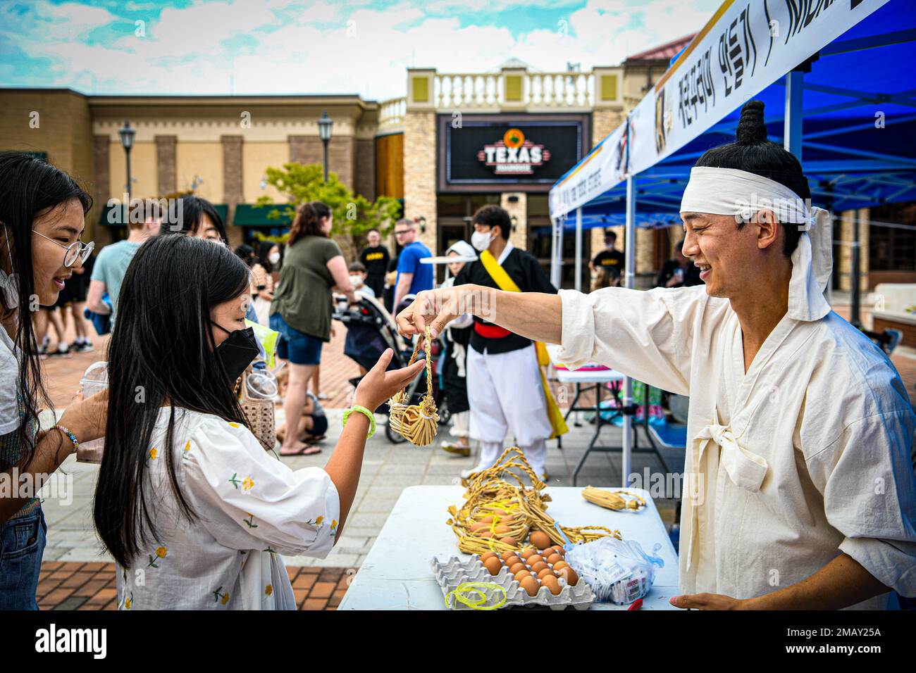 Families explore cultural booths in Downtown Plaza on Camp Humphreys ...