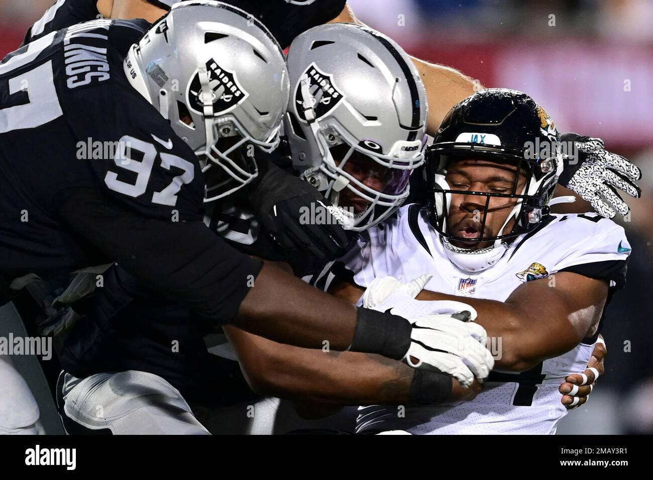 Jacksonville Jaguars running back Snoop Conner, right, is tackled by ...