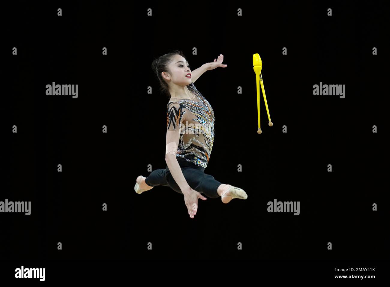 Izzah Binti Amzan Of Malaysia Performs With The Clubs In The Individual All Around Rhythmic