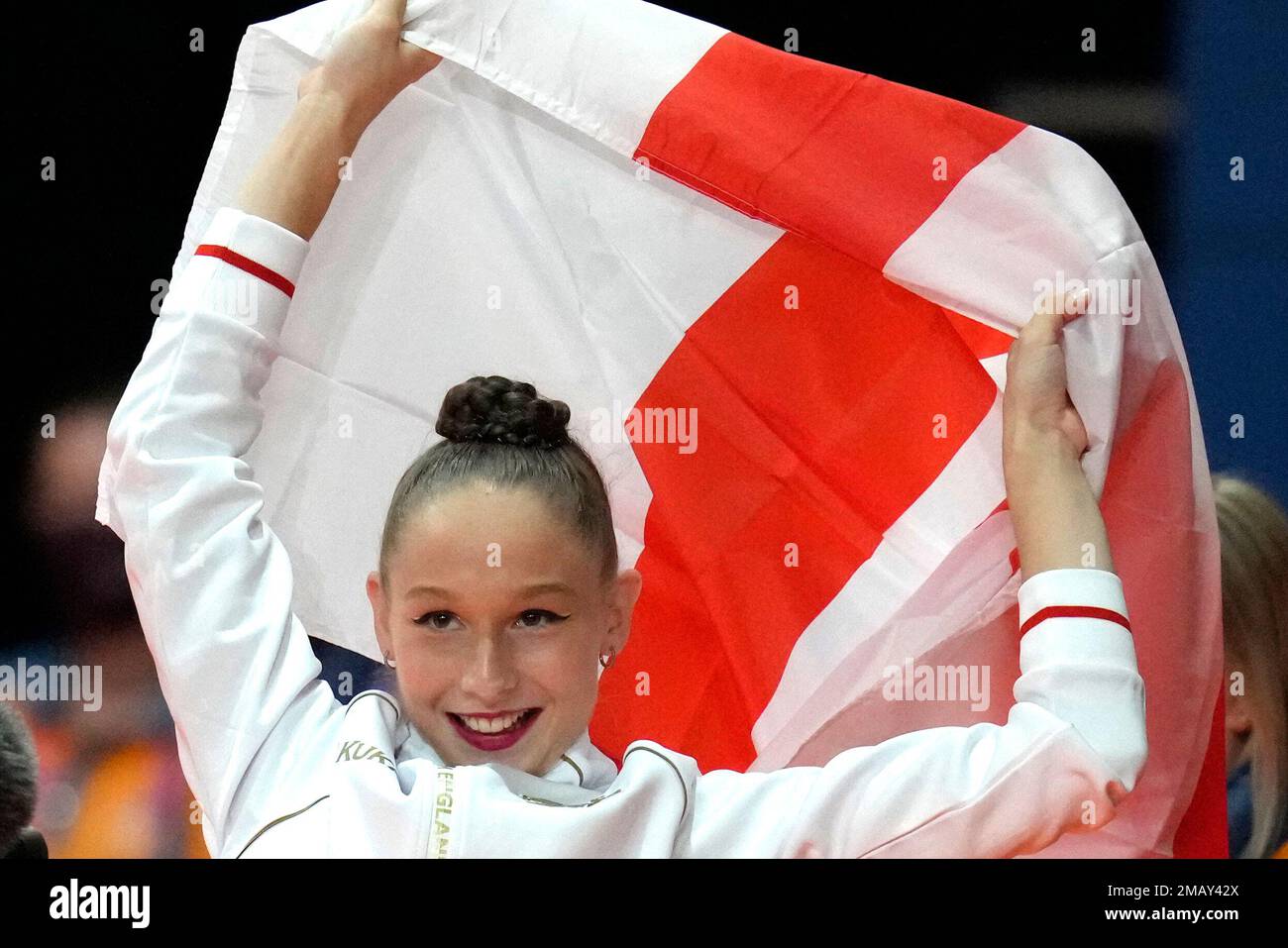 Marfa Ekimova of England holds up the flag of England after winning in ...