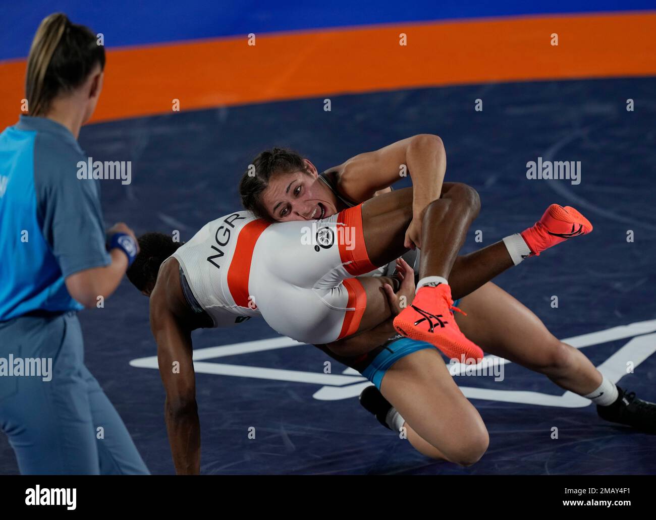 Canada's wrestler Ana Godinez , top, wrestles with Nigeria's Esther ...