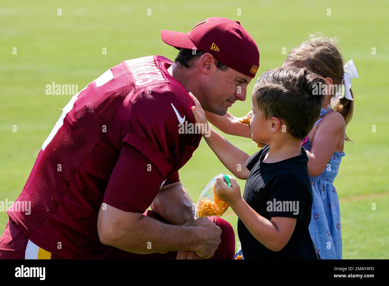 Washington Commanders punter Tress Way shows his children his pads and ...