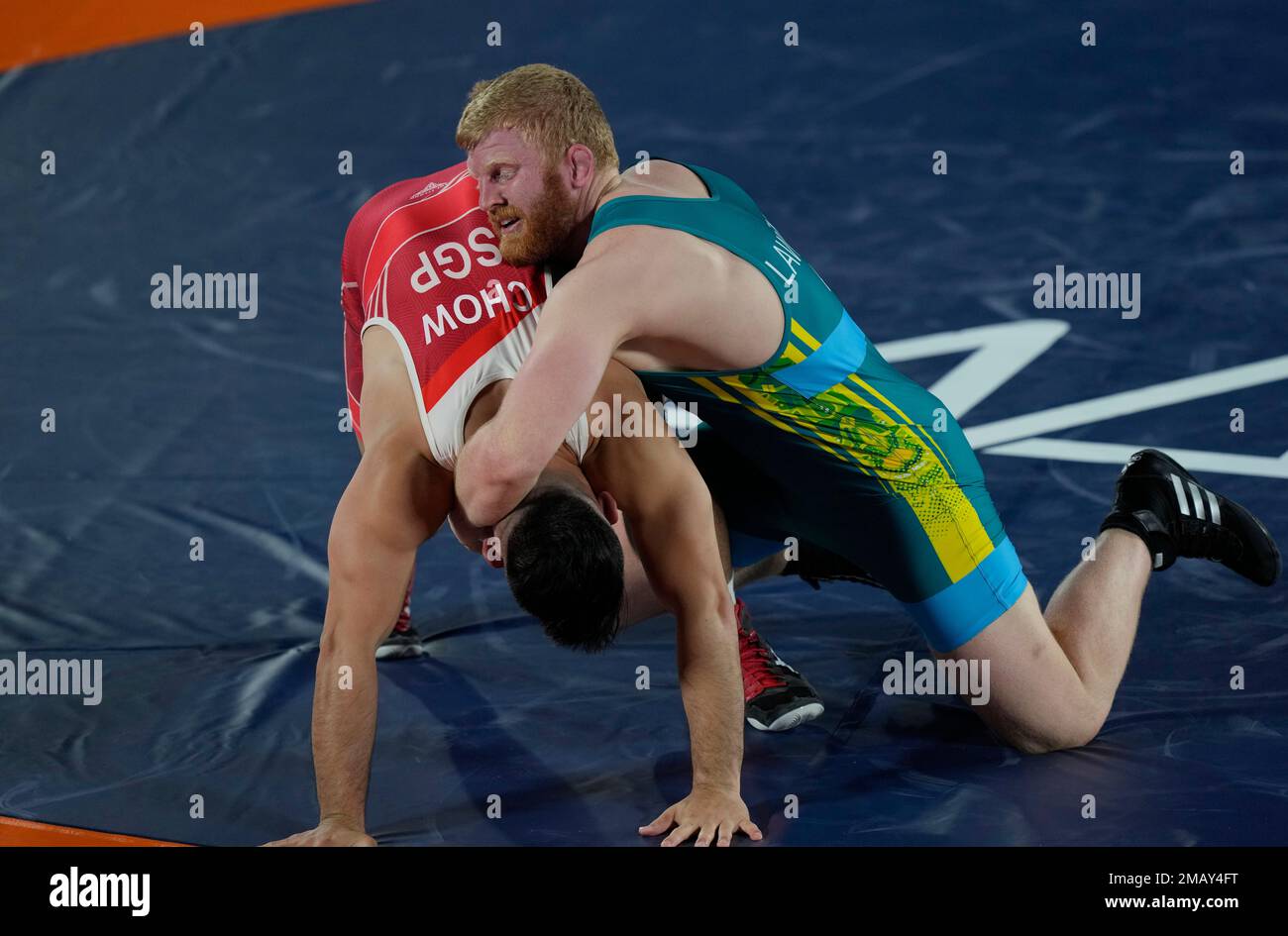 Australia's Jayden Lawrence, right, wrestles with Singapore's Gary Chow ...
