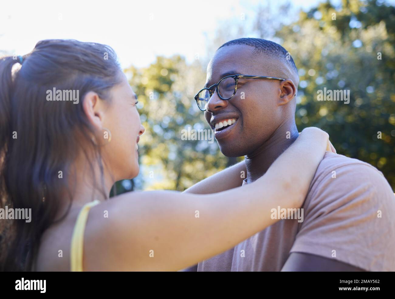 Interracial Couple Smile And Hug For Love Care Or Embracing