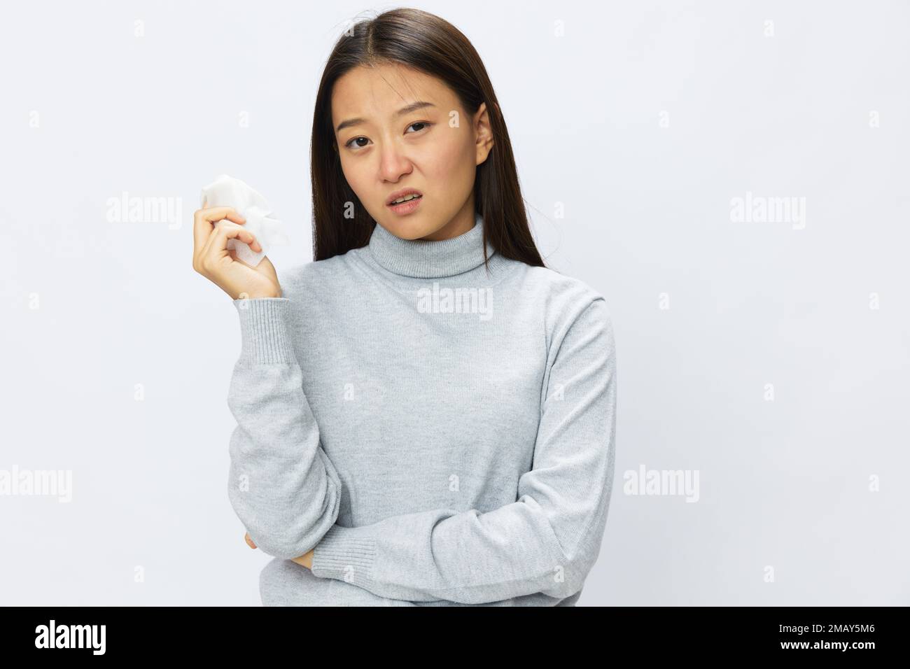 Sad Asian woman holding hand with handkerchief and coughing up flu and ...