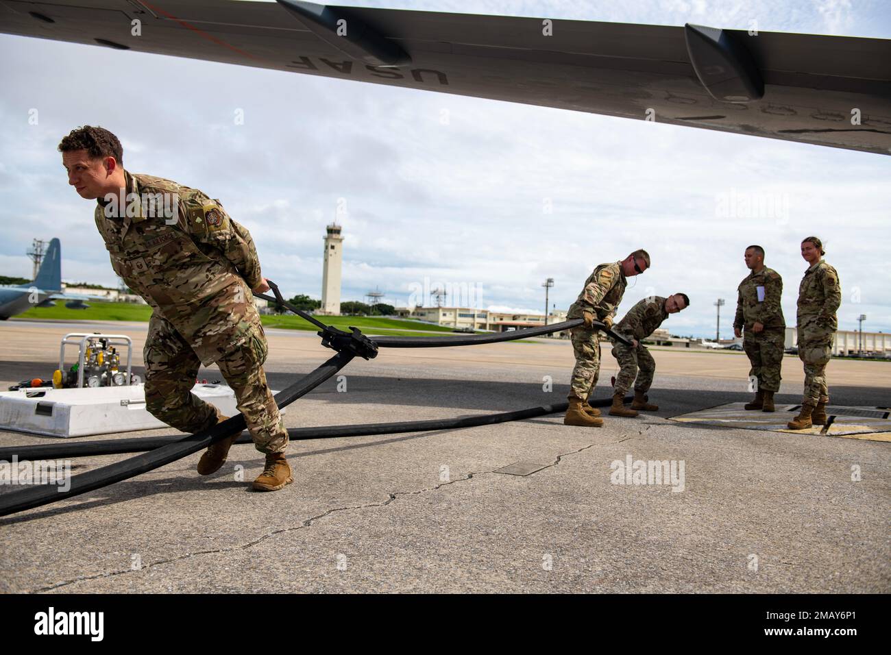 U.S. Air Force Airmen from the 18th Logistics Readiness Squadron work alongside Airmen from ...