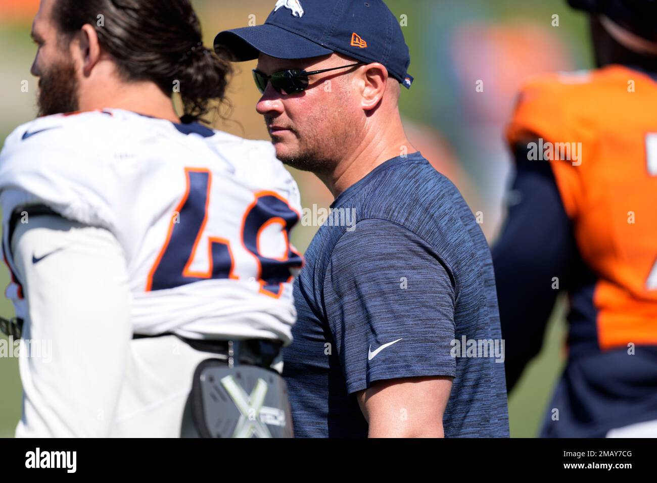 Denver Broncos head coach Nathaniel Hackett takes part in drills during ...