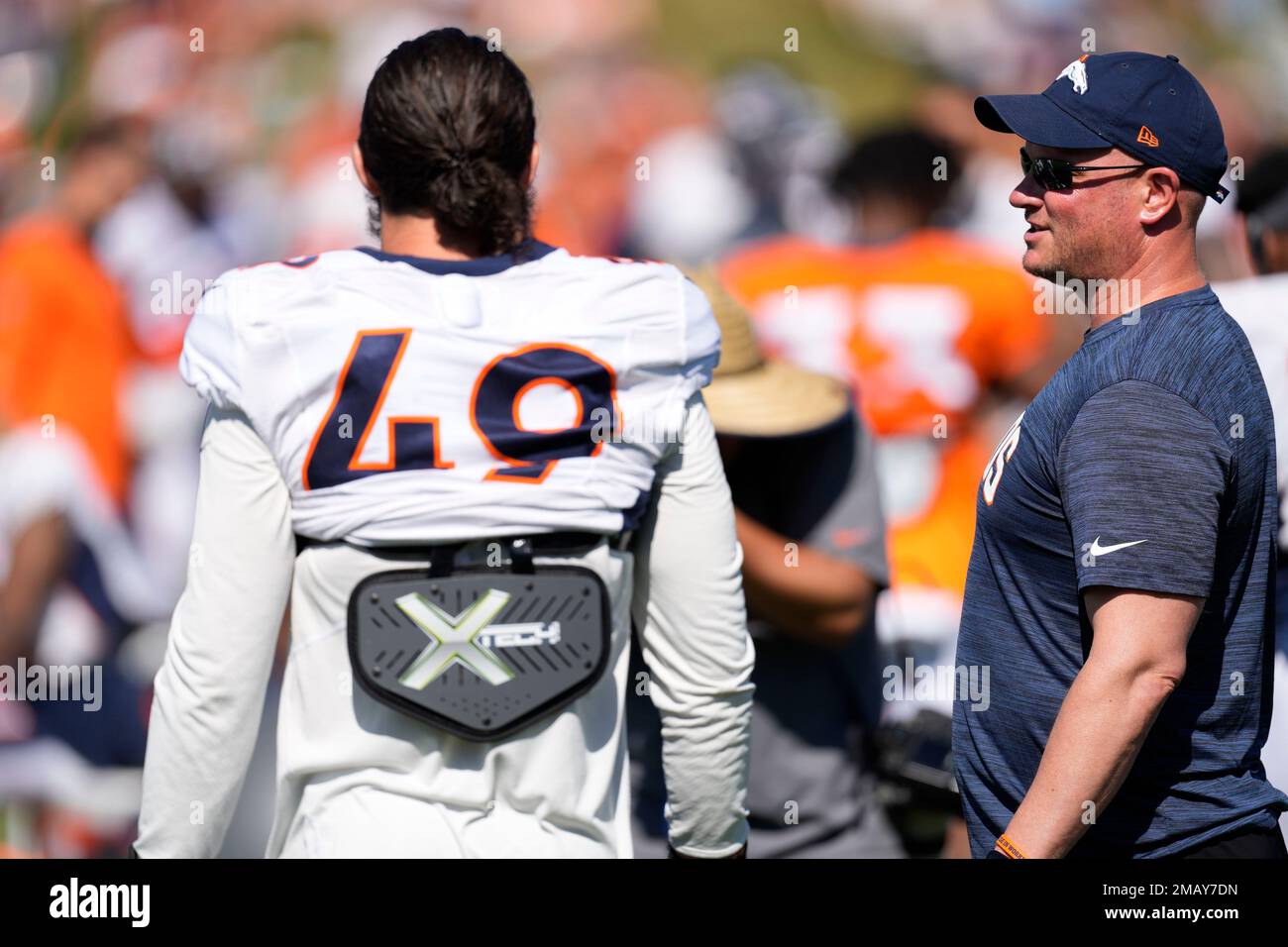 Denver Broncos head coach Nathaniel Hackett chats with linebacker Alex ...
