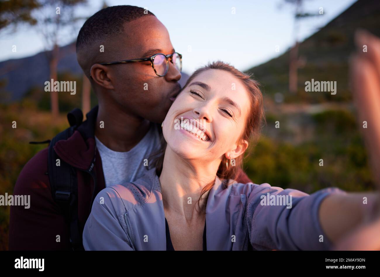 Interracial couple, kiss and smile for selfie, travel or love for ...