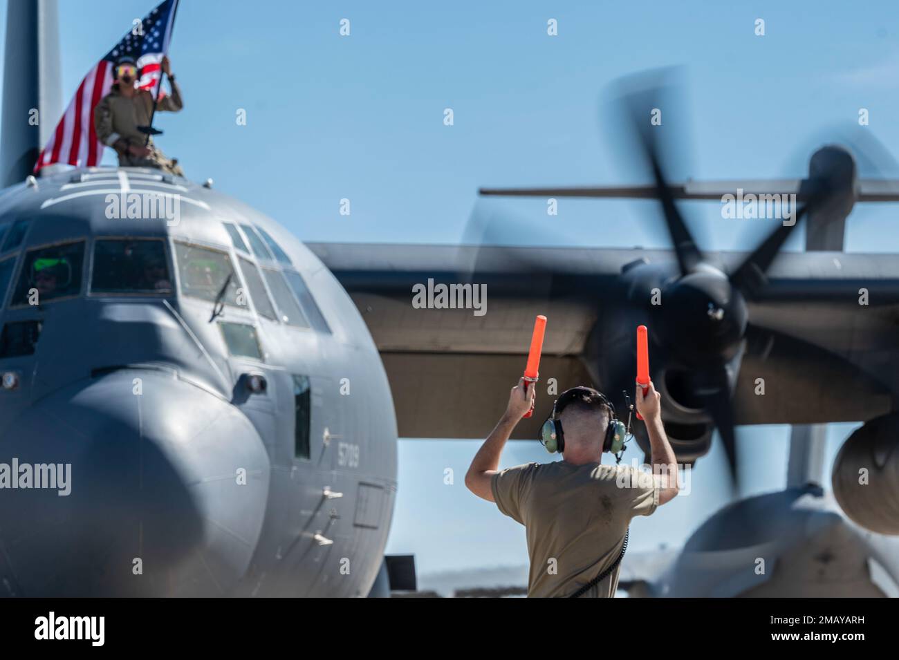 A U.S. Air Force Airman assigned to the 355th Wing marshals an HC-130J ...