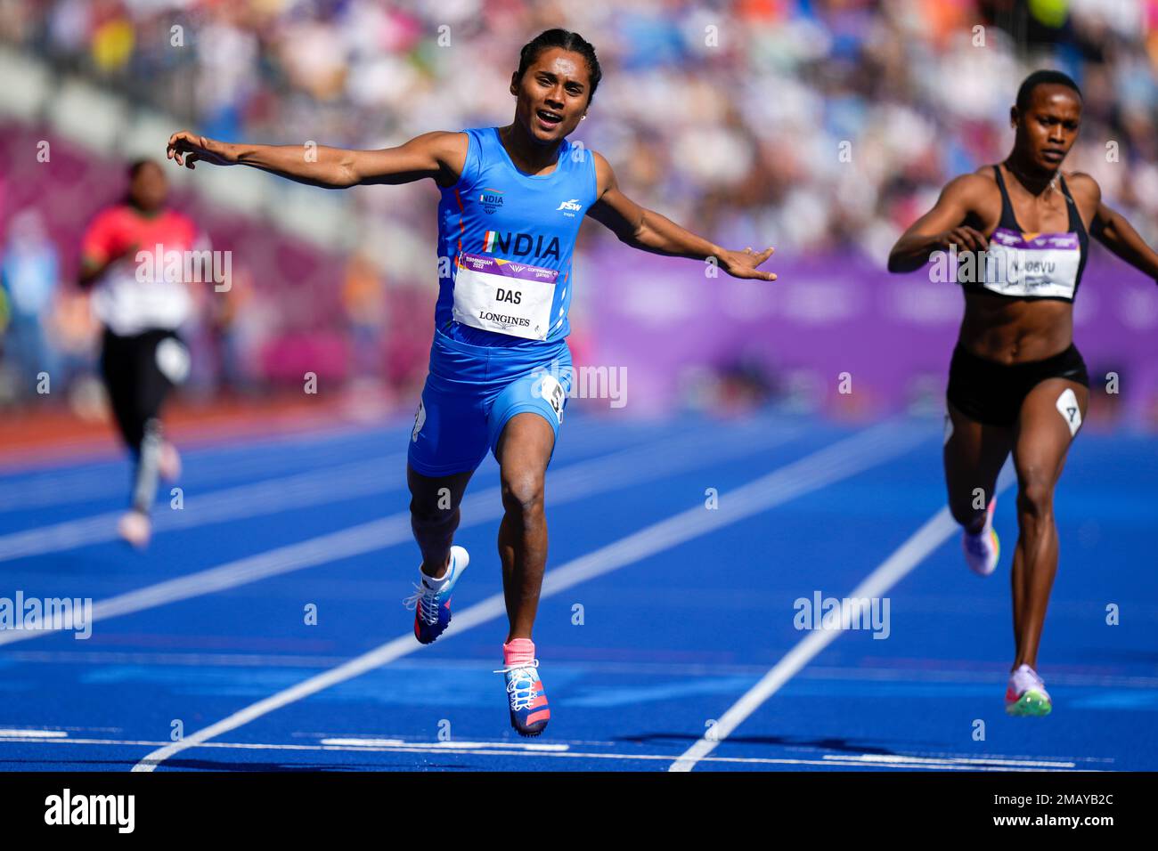 Hima Das of India reacts as she crosses the finish line in her heat of ...