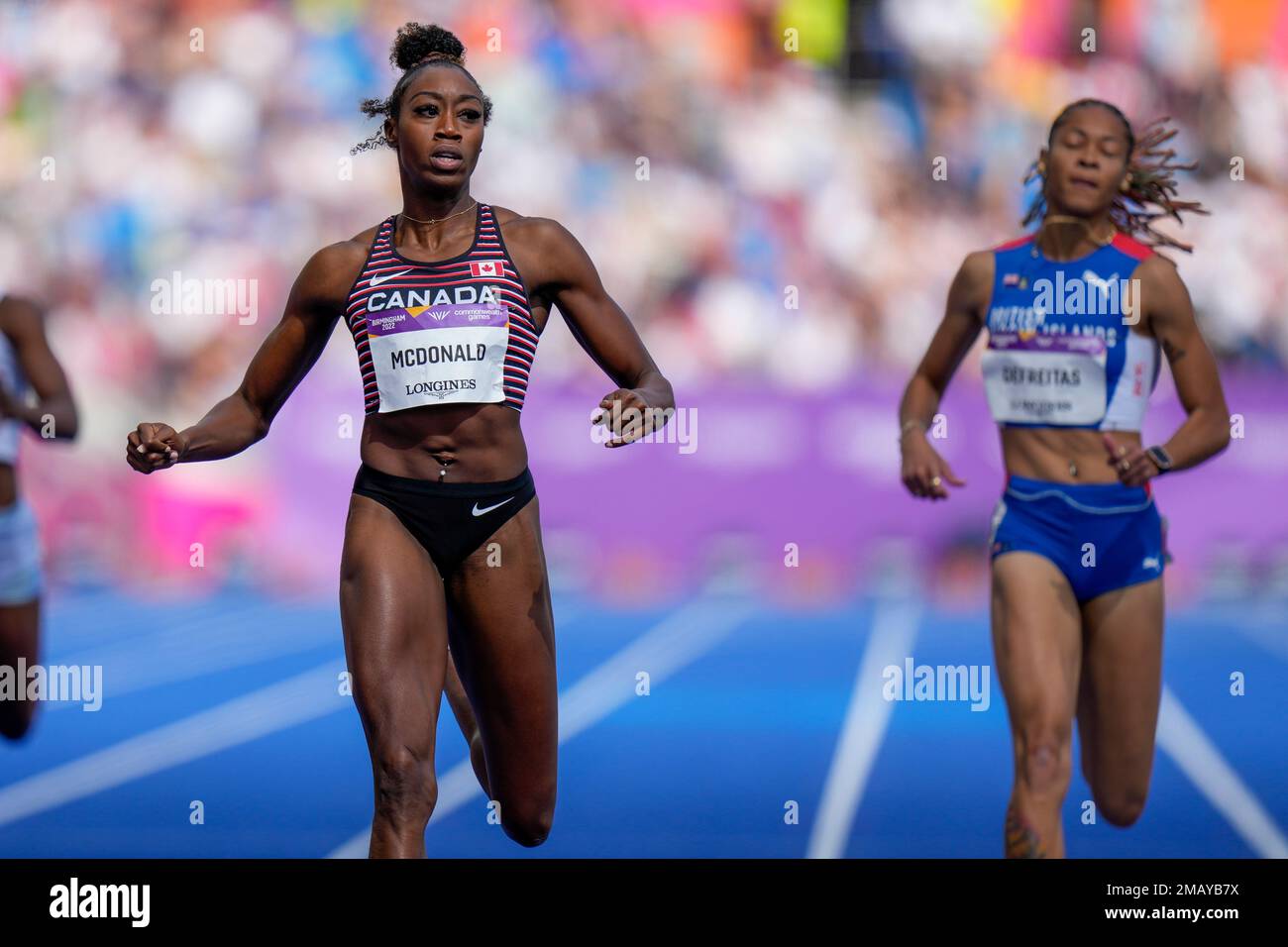Natassha McDonald of Canada races in her heat of the women's 200 meters ...