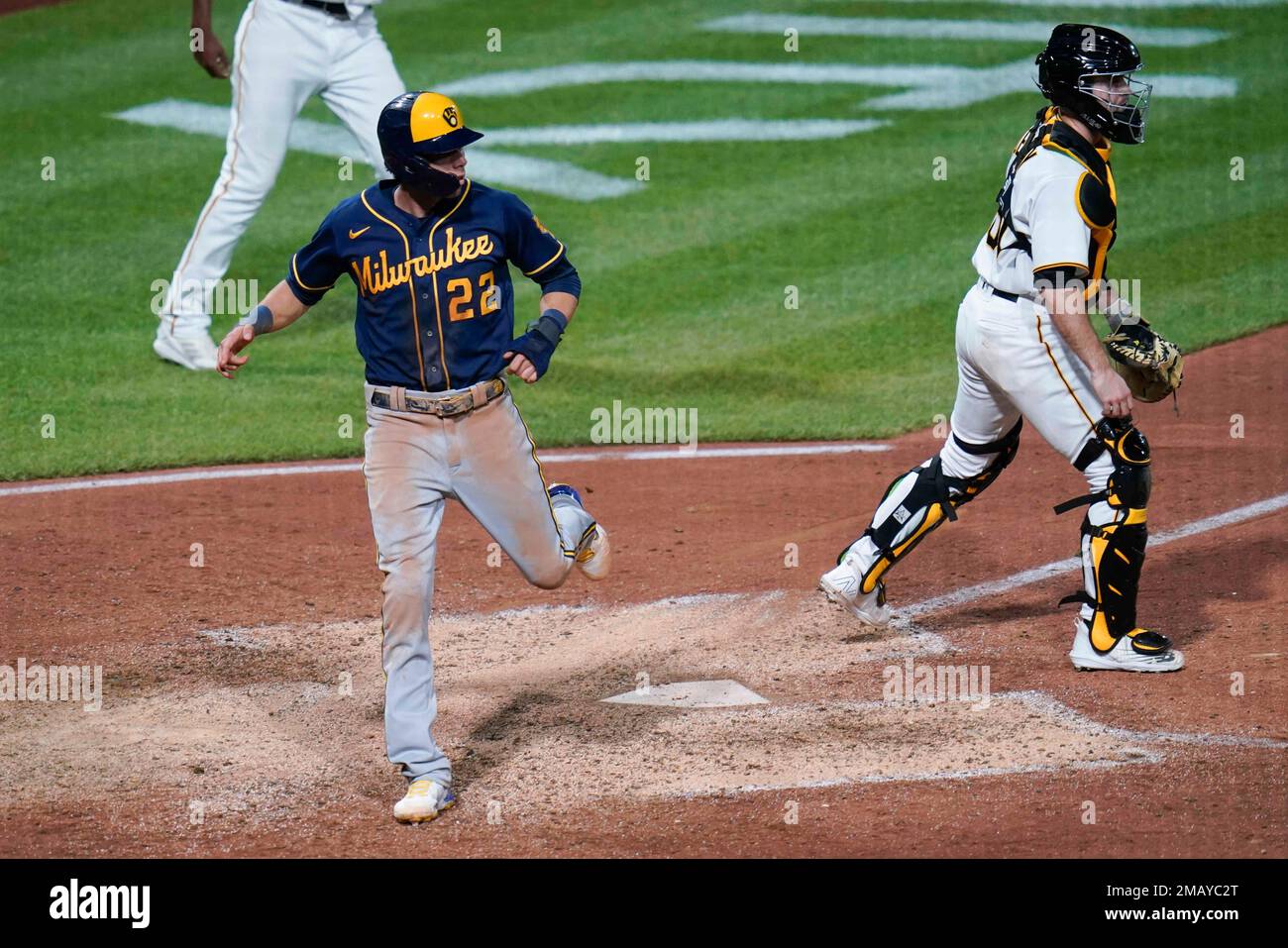 Milwaukee Brewers' Christian Yelich (22) scores next to Pittsburgh ...