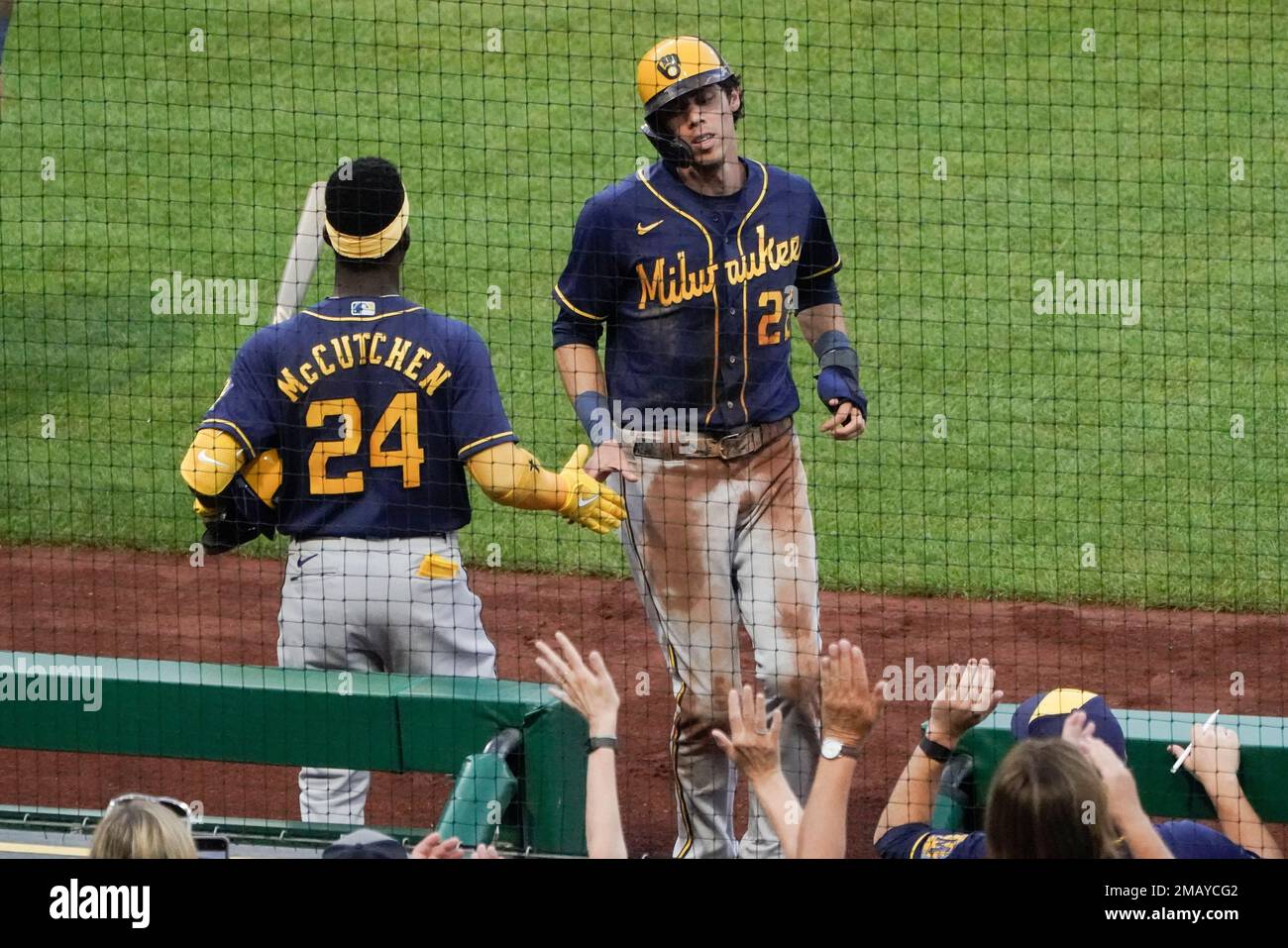 Milwaukee Brewers' Christian Yelich (22) is greeted by Andrew McCutchen ...