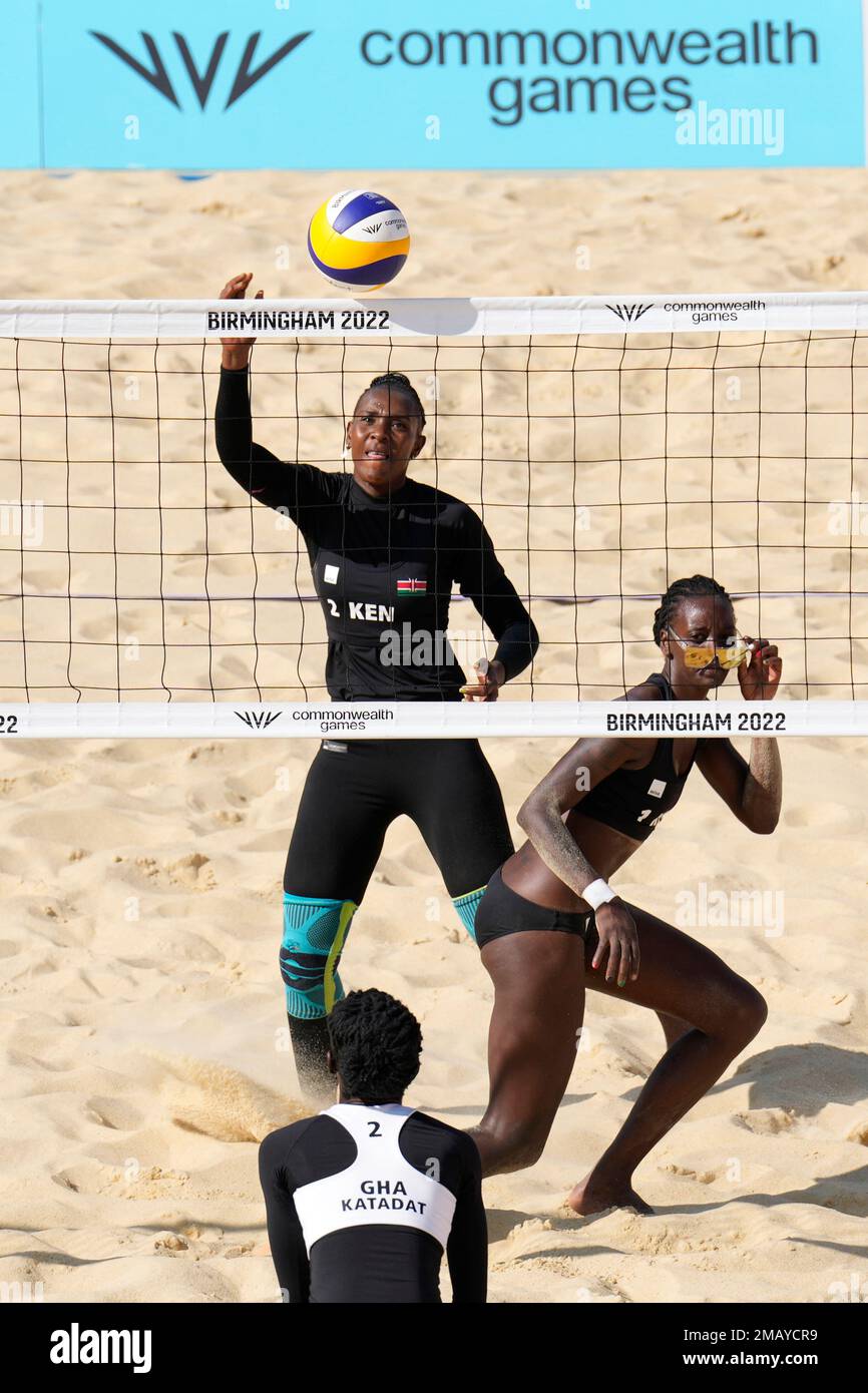 Kenya's Brackcides Khadambi, left, spikes the ball to Ghana's Rashaka ...