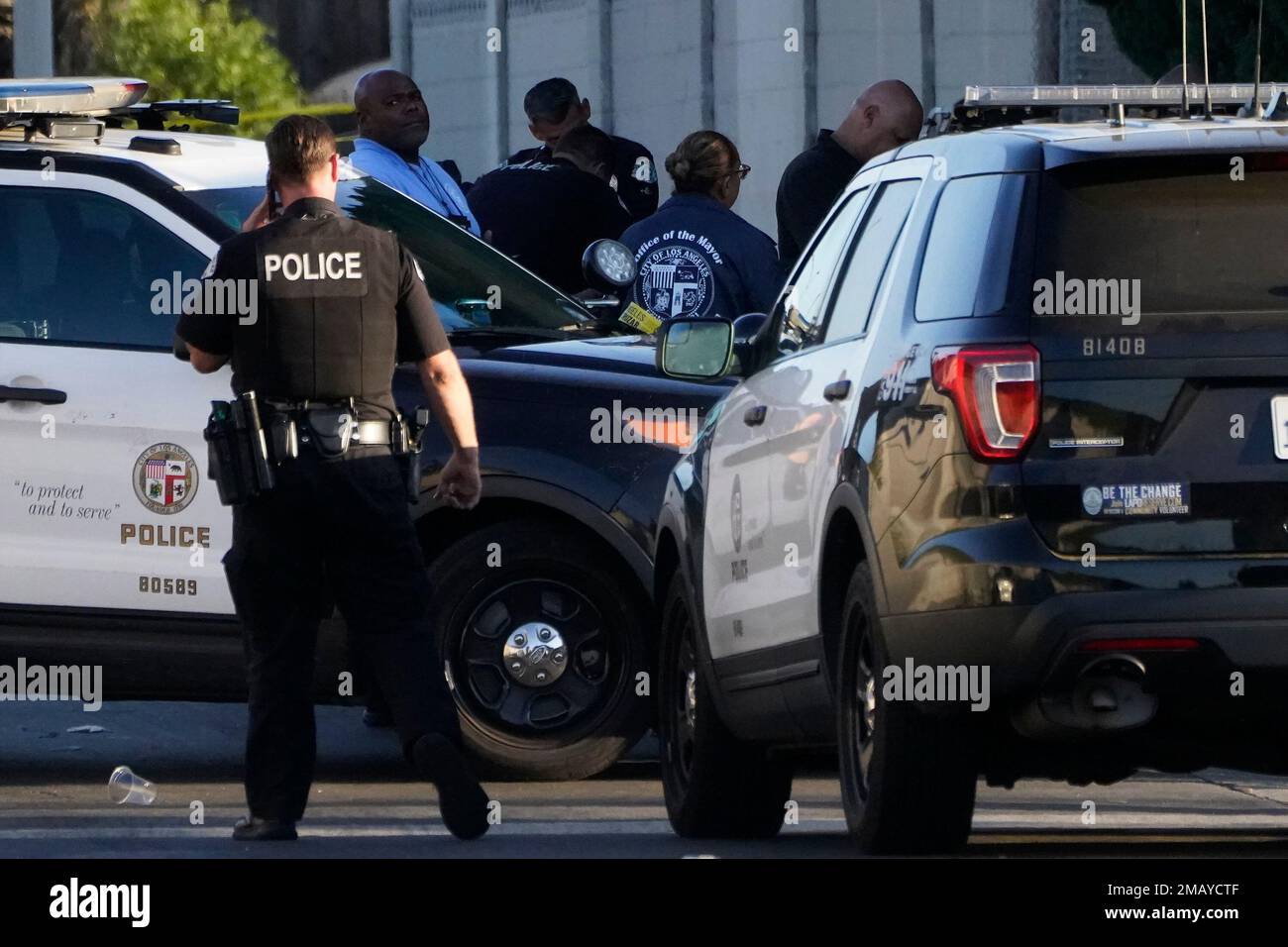A Los Angeles Police officer and members of the Office of the Mayor of ...