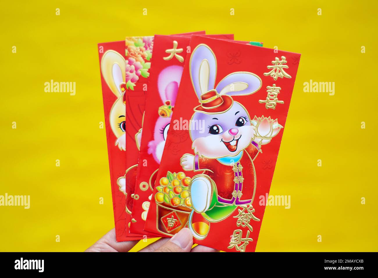 Theme red envelopes with rabbit, Chinese blessing words on yellow ...