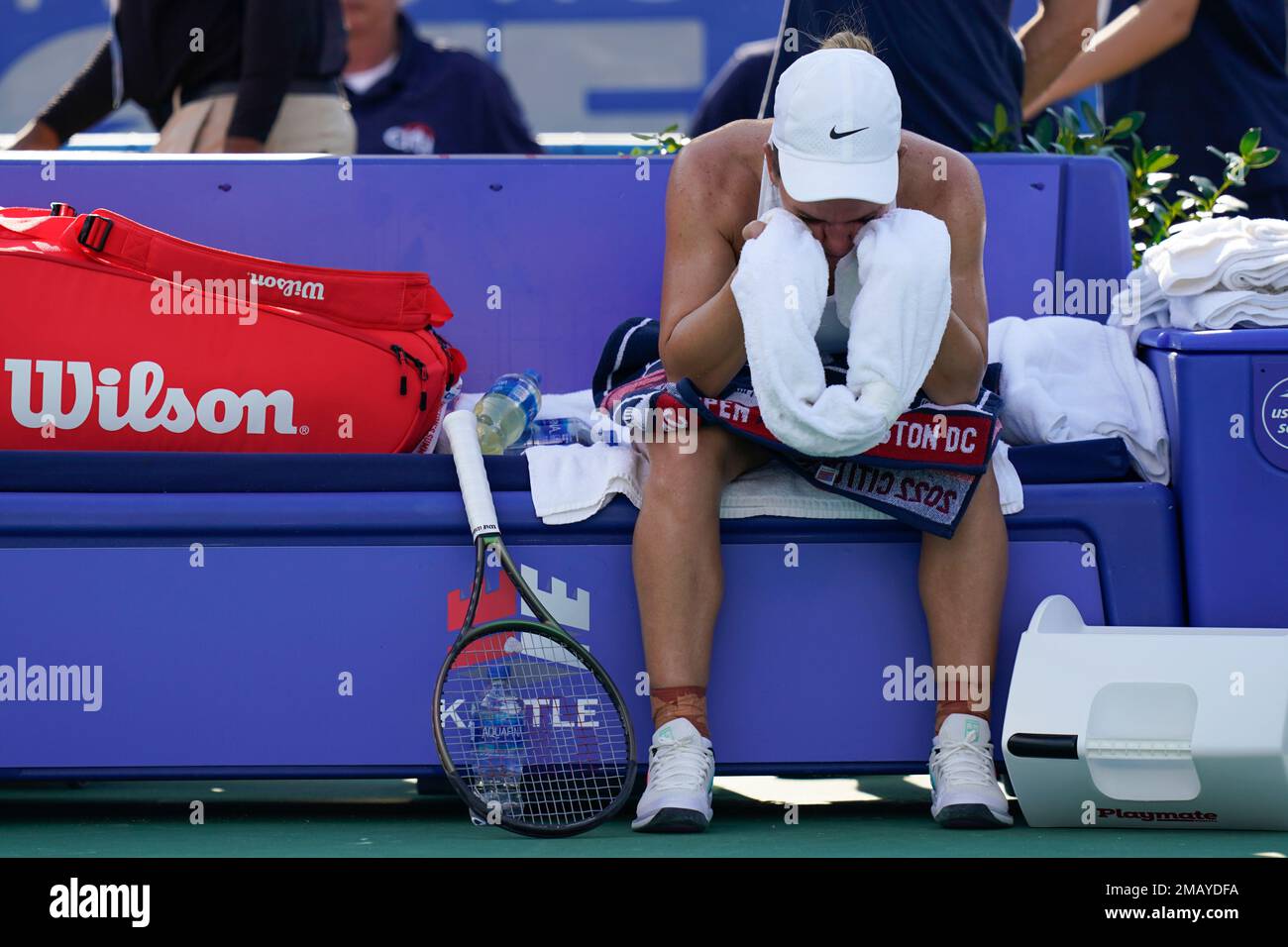 Romania's Simona Halep holds cold towels to her face before retiring ...