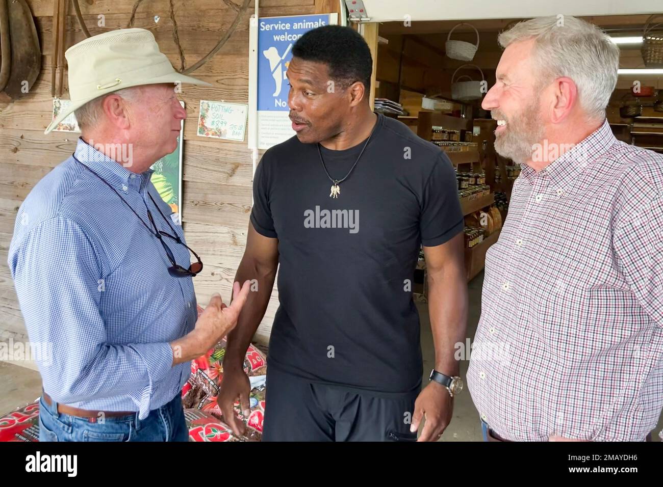 FILE - Republicans U.S. Senate candidate Herschel Walker, center, talks ...