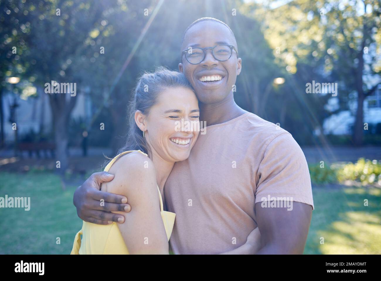Happy interracial couple, hug and laughing in joy for bonding ...