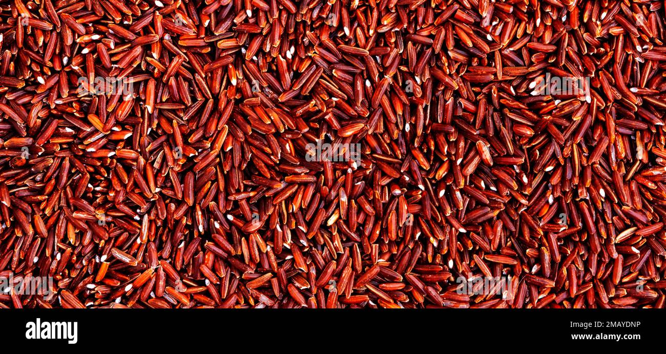 Wild raw red rice groats, food background texture, top view horizontal ...