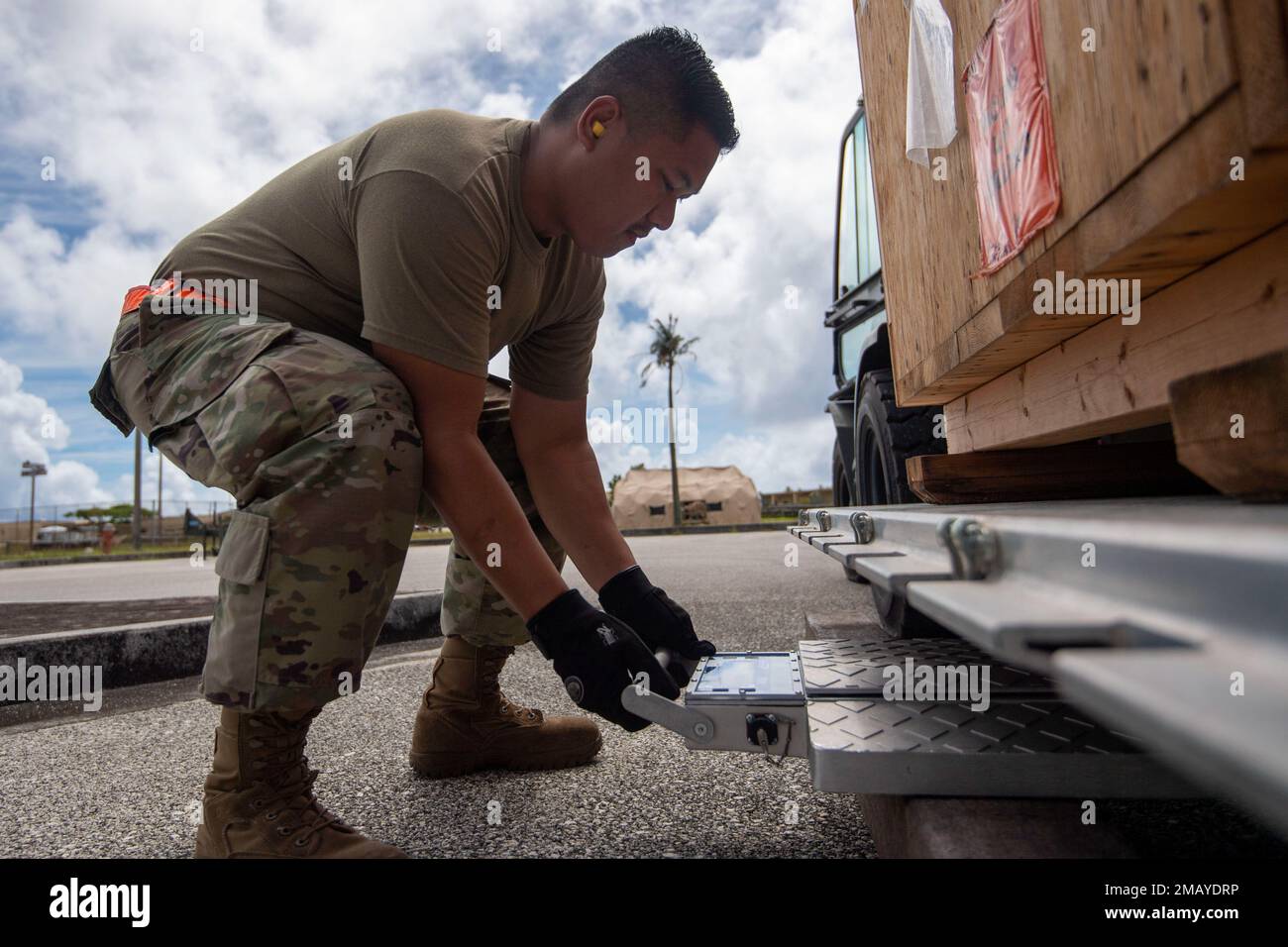 Master Sgt. Bedrick Briones positions a scale to weigh cargo during ...