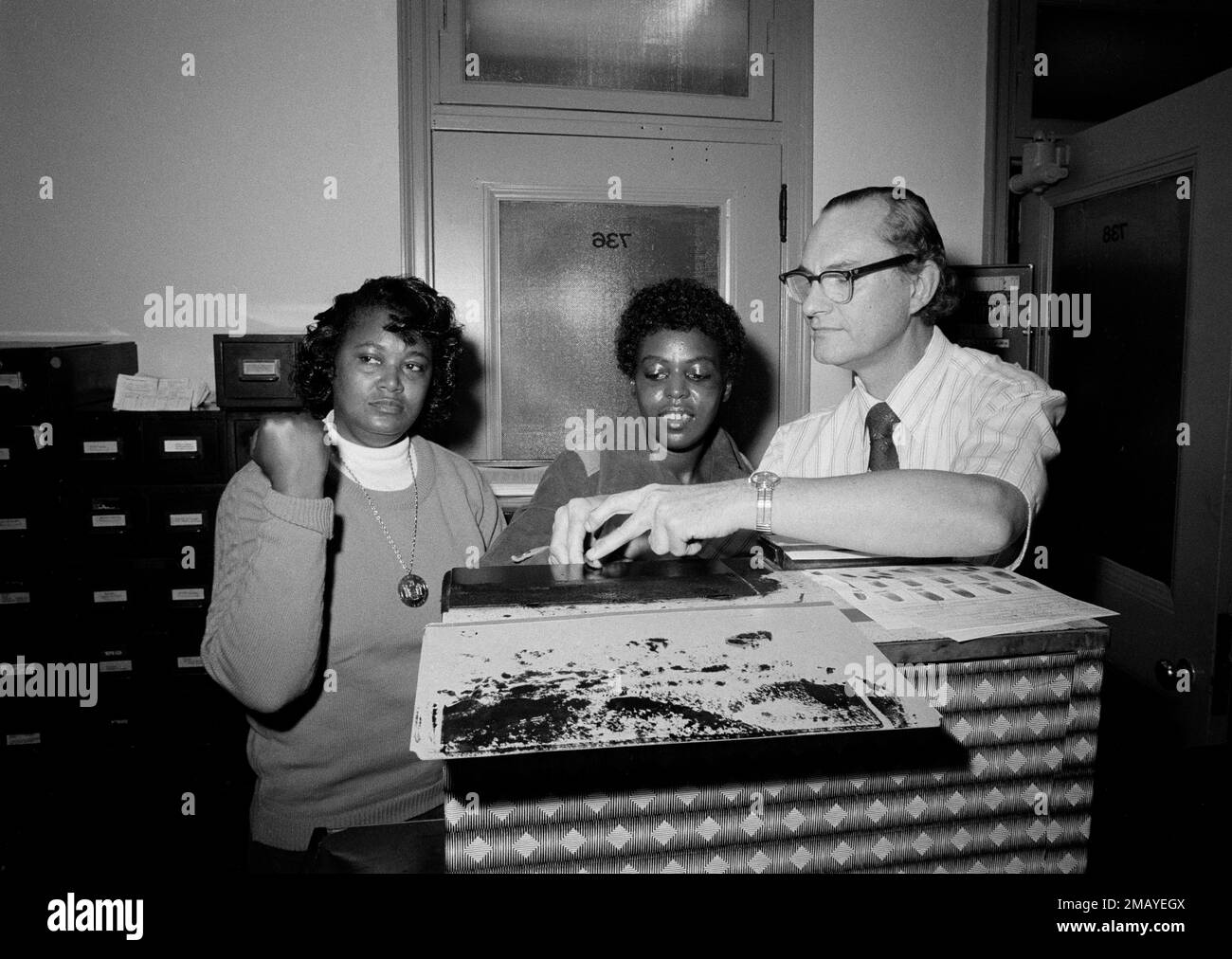 Jackie Tonawanda, left, and Marian Tyger Trimiar are fingerprinted in ...