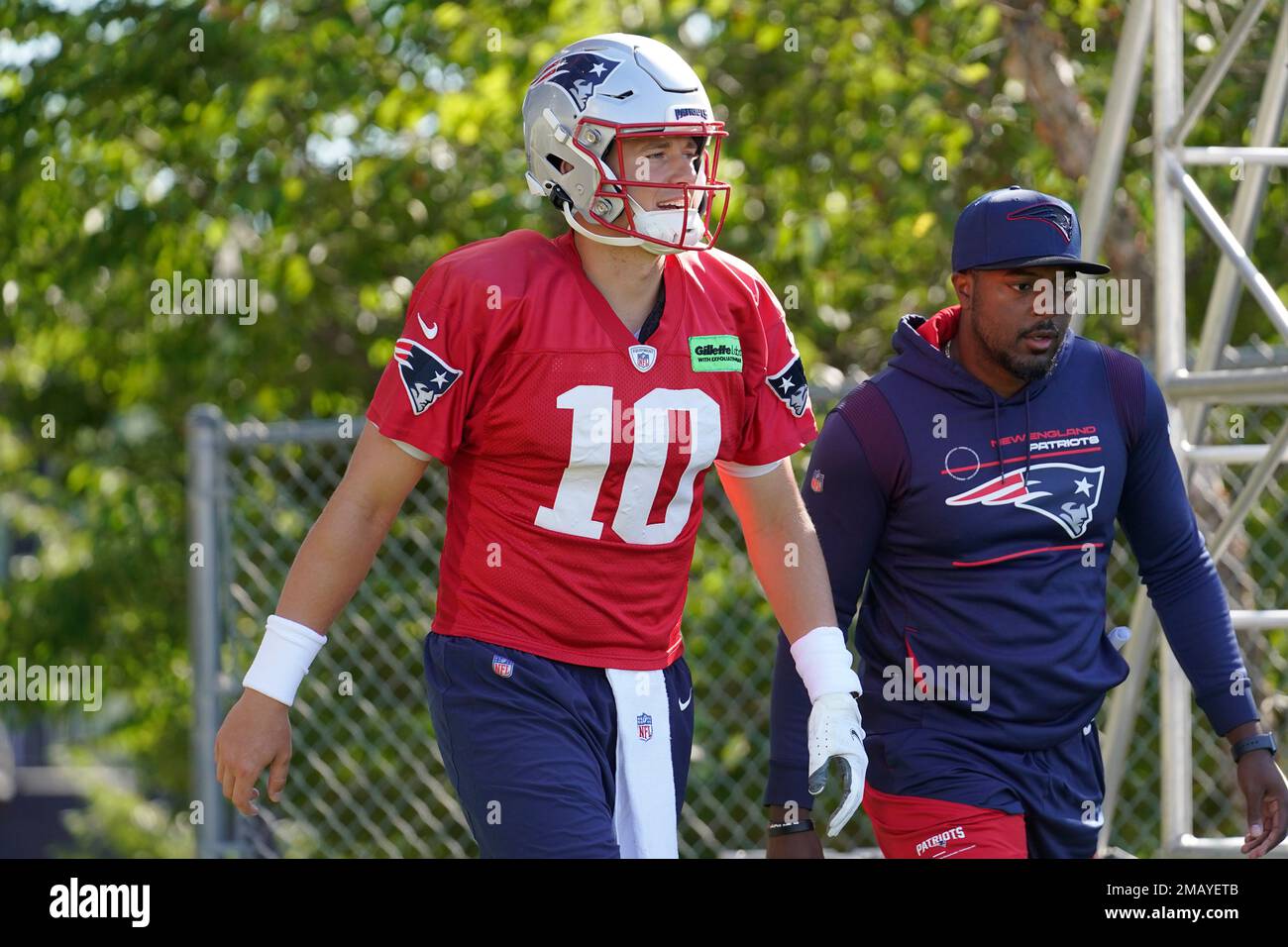New England Patriots quarterback Mac Jones (10) steps on the field for ...